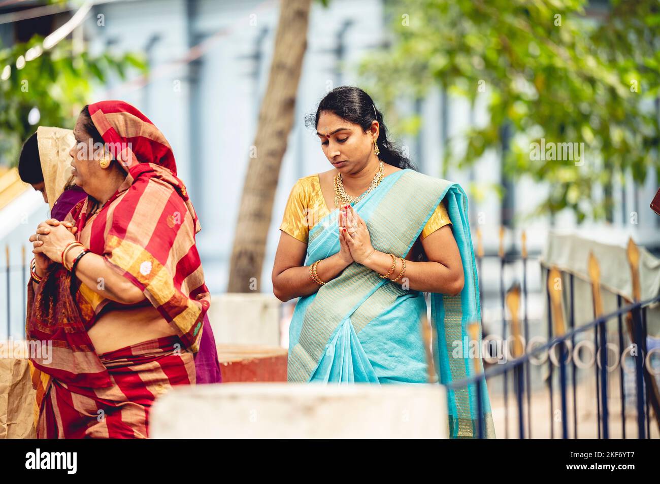 The women praying to idols and guards at the Narasimha Hindu temple in ...