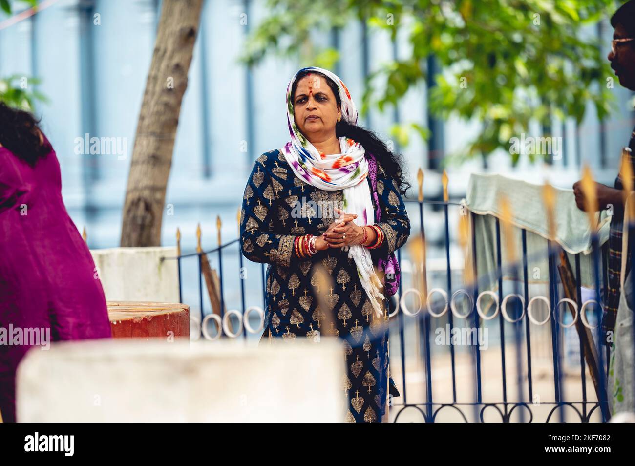 A woman praying to idols and guards at the Narasimha Hindu temple in ...