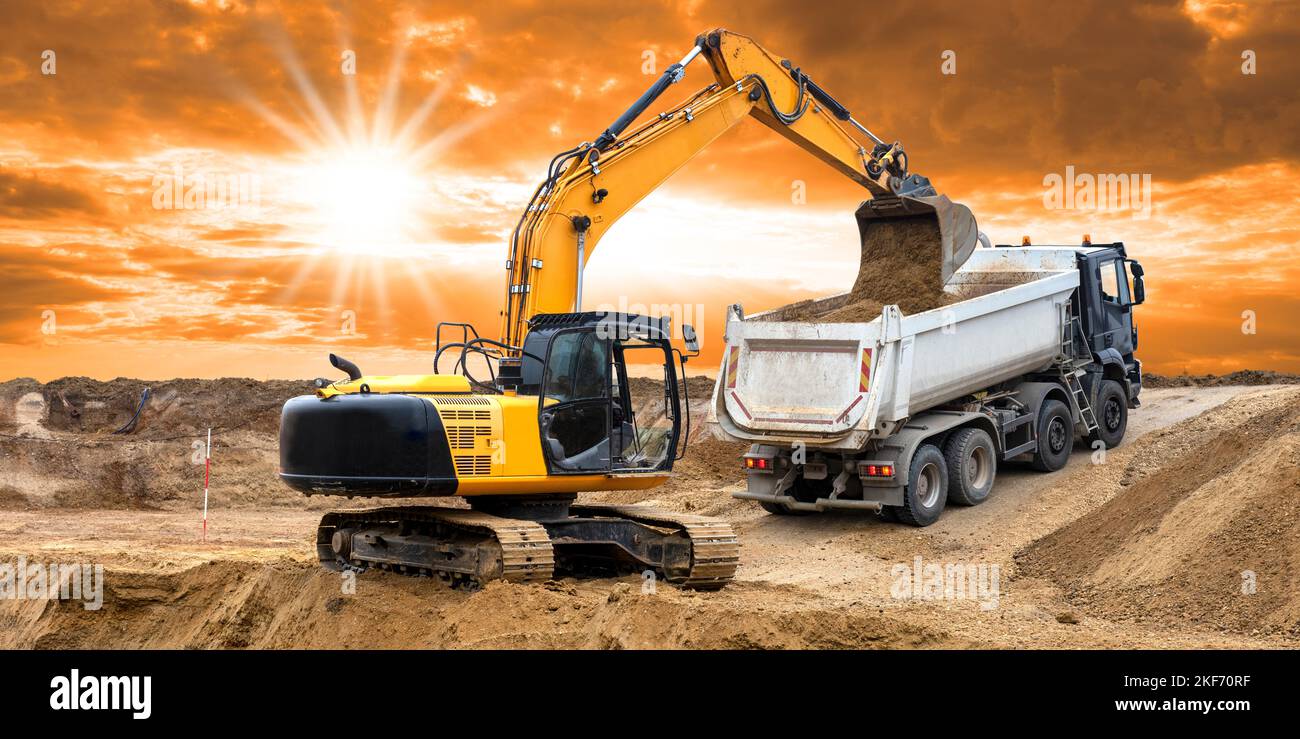 excavator is digging and loading at construction site Stock Photo - Alamy