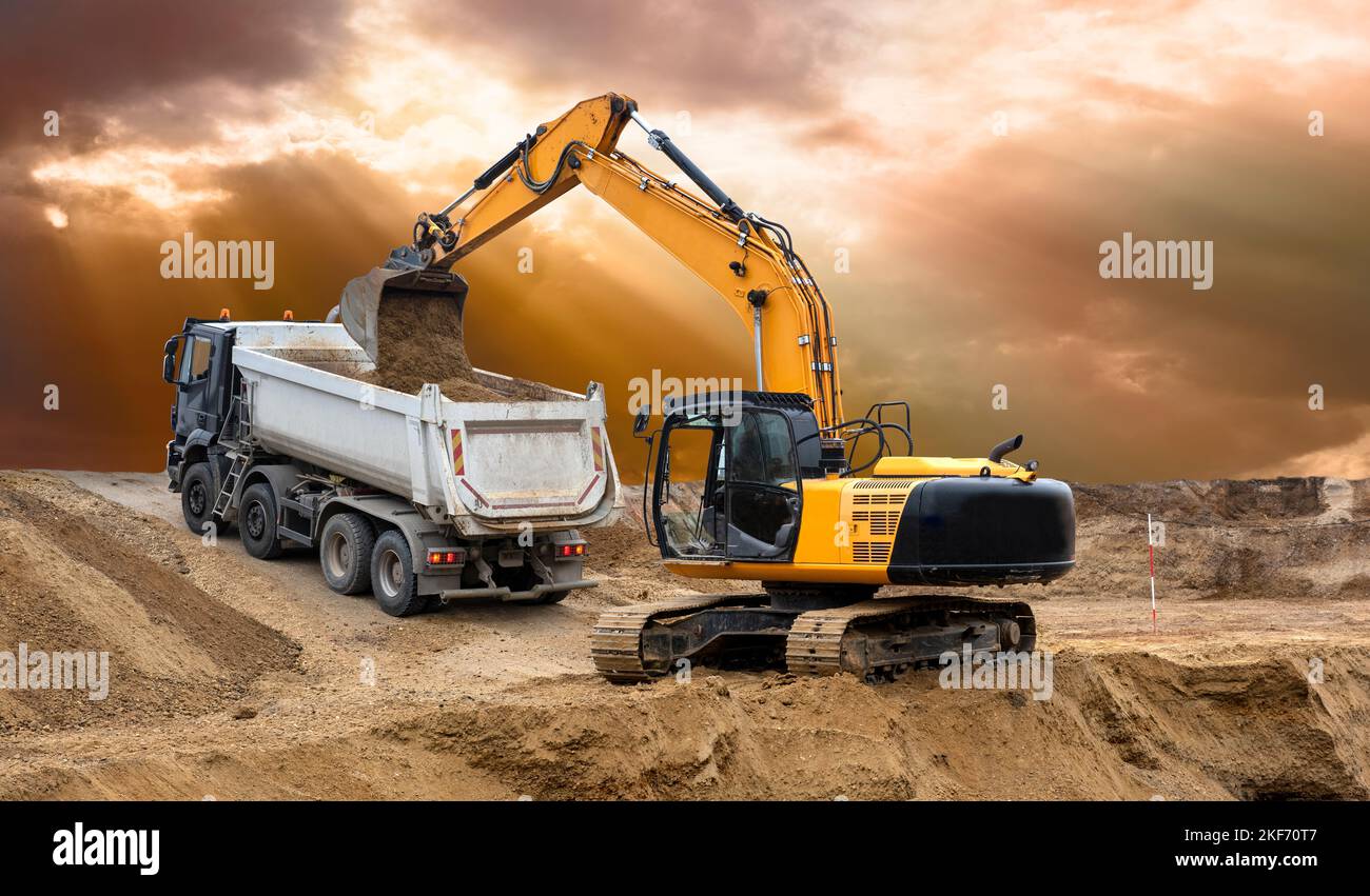 excavator is digging and loading at construction site Stock Photo - Alamy