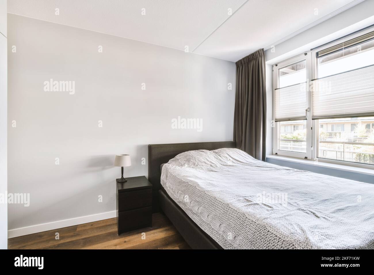 Home interior design of bedroom with bed and wooden wardrobe placed in ...