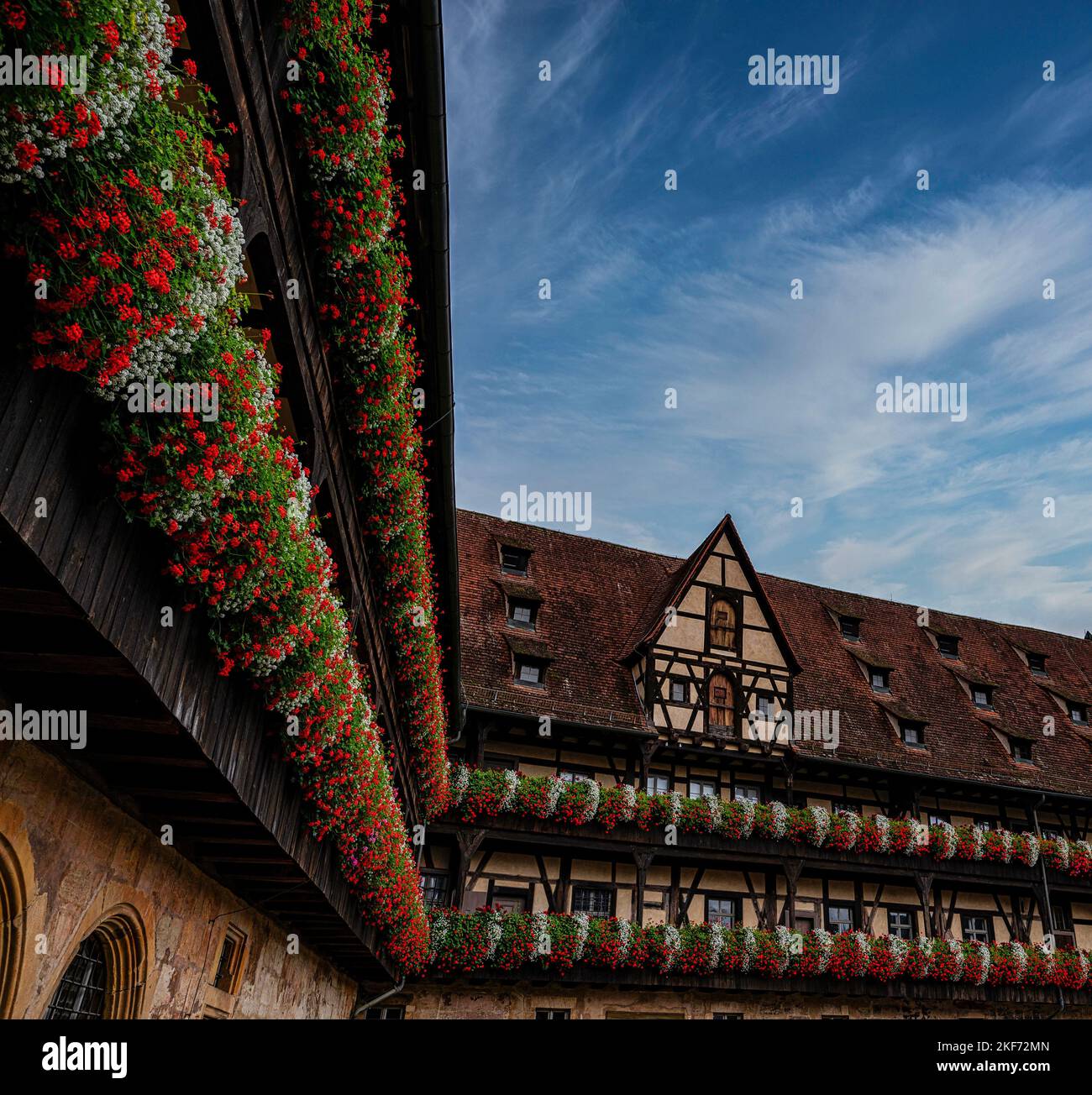 close up shot of wooden balcony with colorful flowers at historic ...