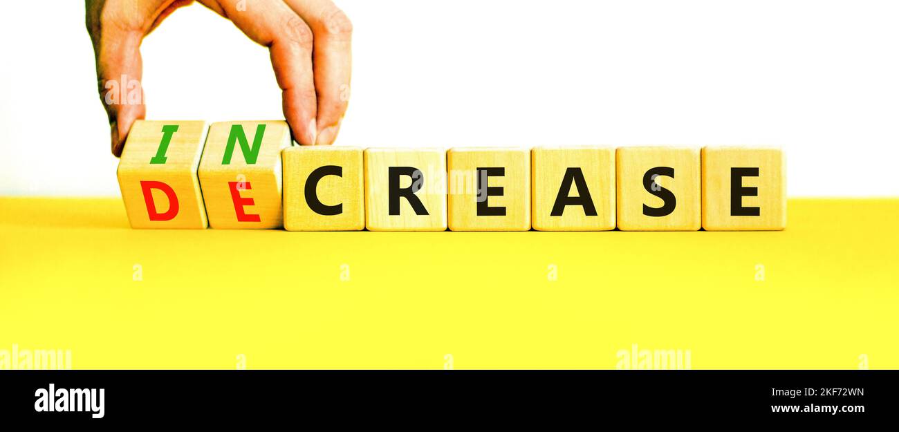 Increase or decrease symbol. Concept words Increase and Decrease on wooden cubes. Businessman ...