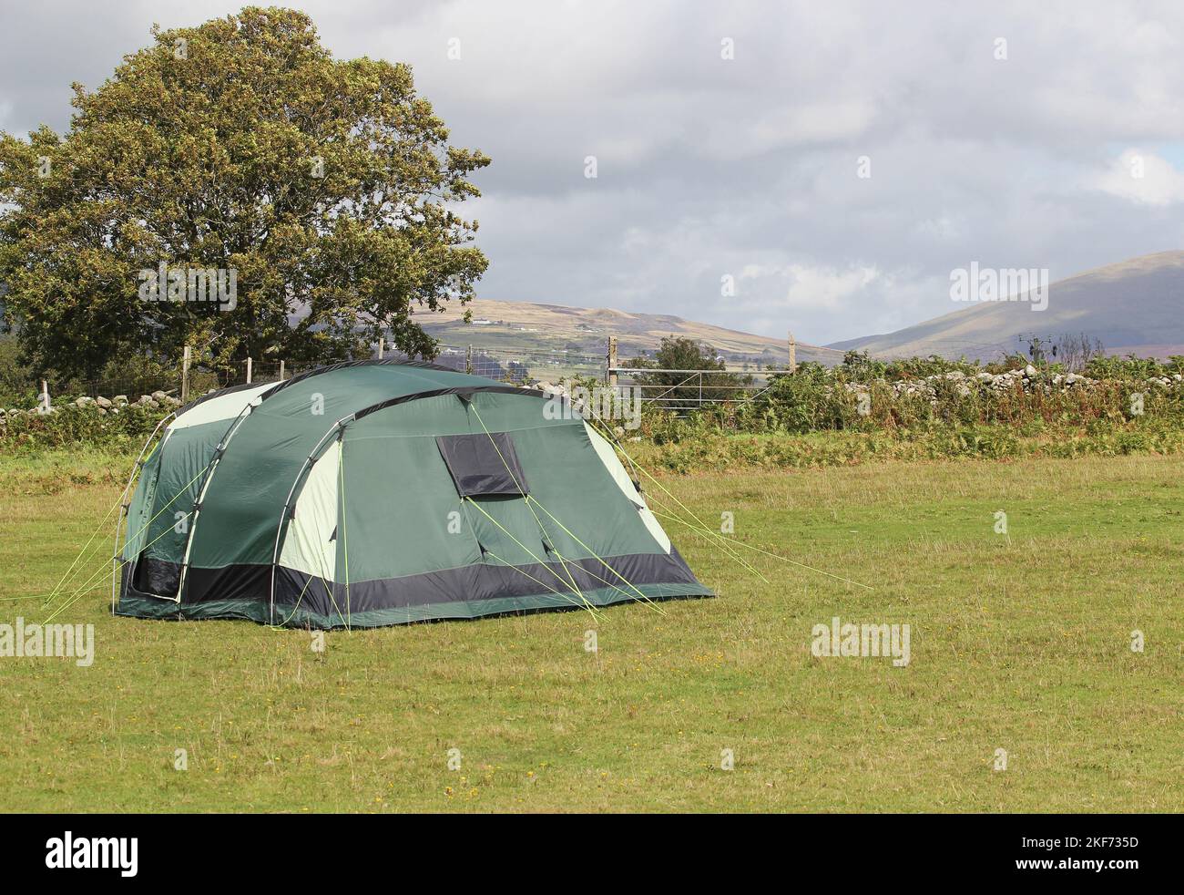 Camping. Tent pitched in a green field to camp Stock Photo - Alamy