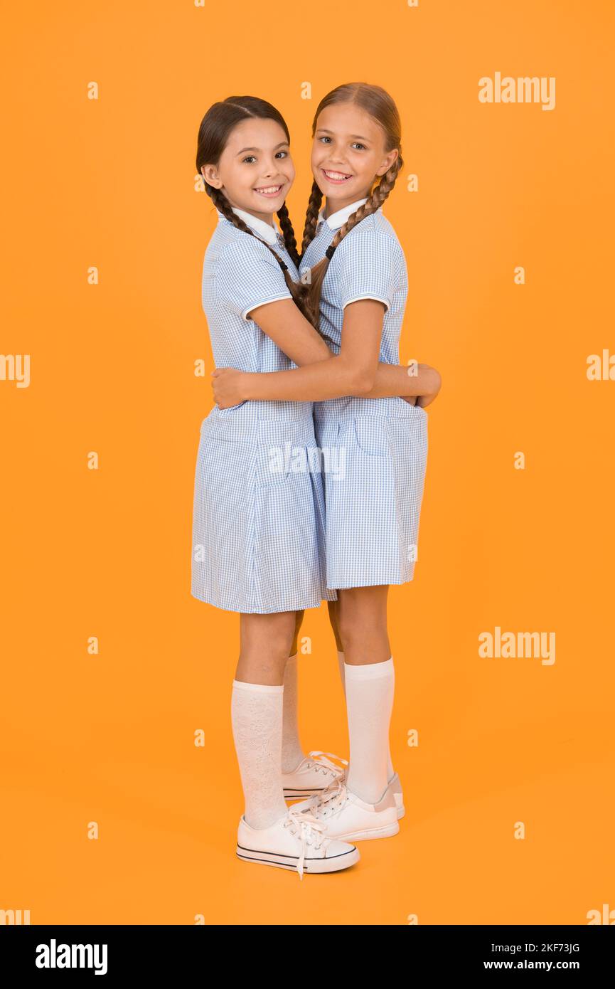 Friendly hug. Beautiful schoolgirls best friends. Back to school ...