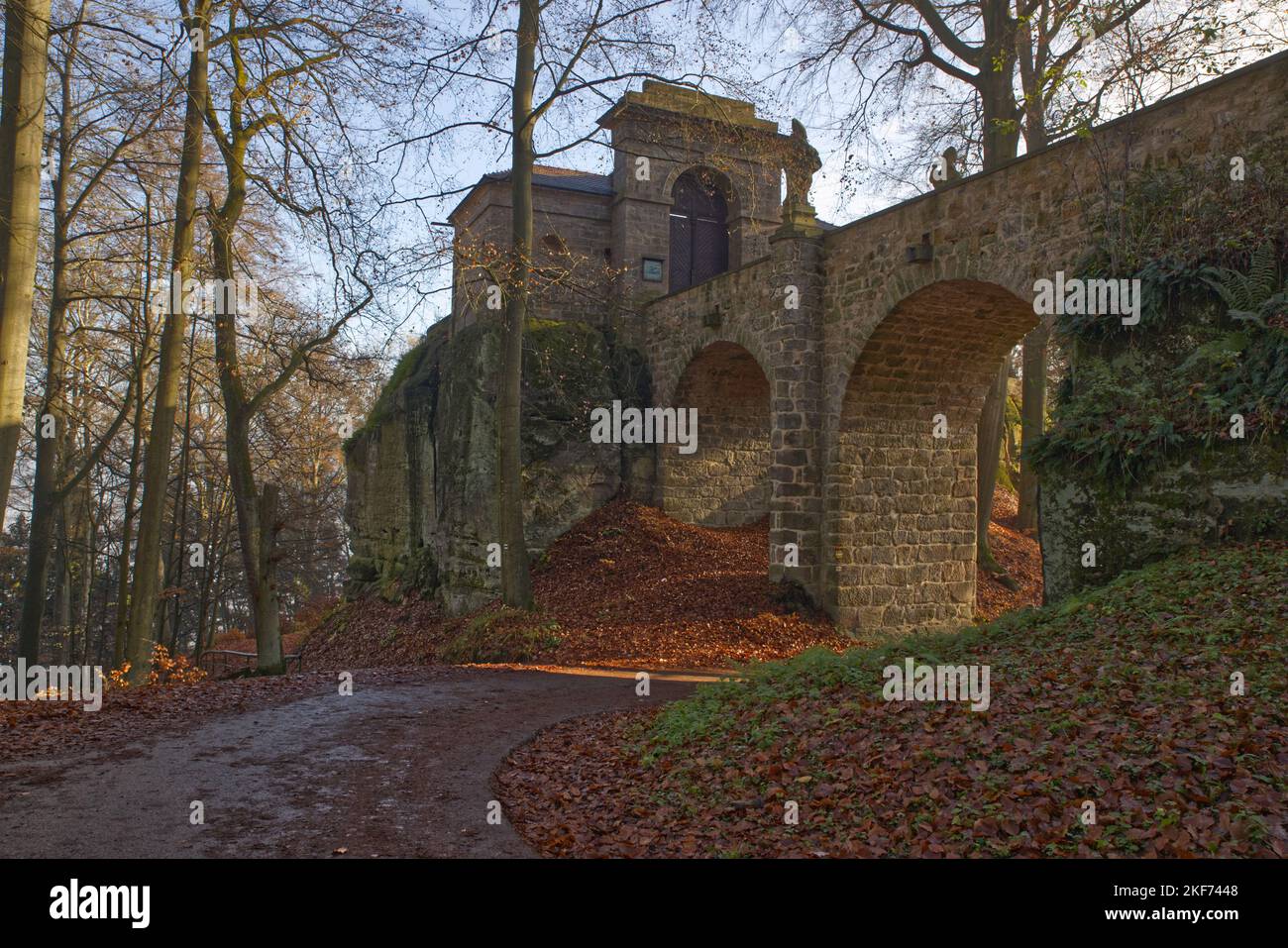 European medieval castle situated in forest in the autumn day, blue sky ...