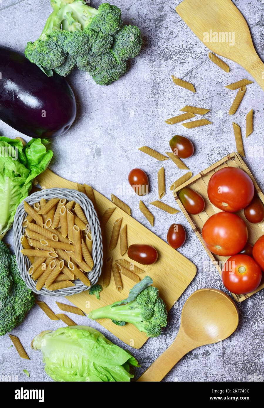 A top view of healthy food and wooden cutlery, wholemeal macaroni pasta ...
