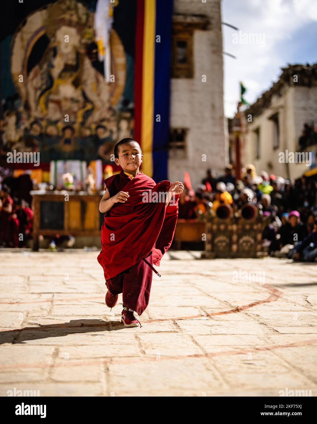 A young Tibetan Buddhist Monk at the ancient Tiji Festival in walled ...