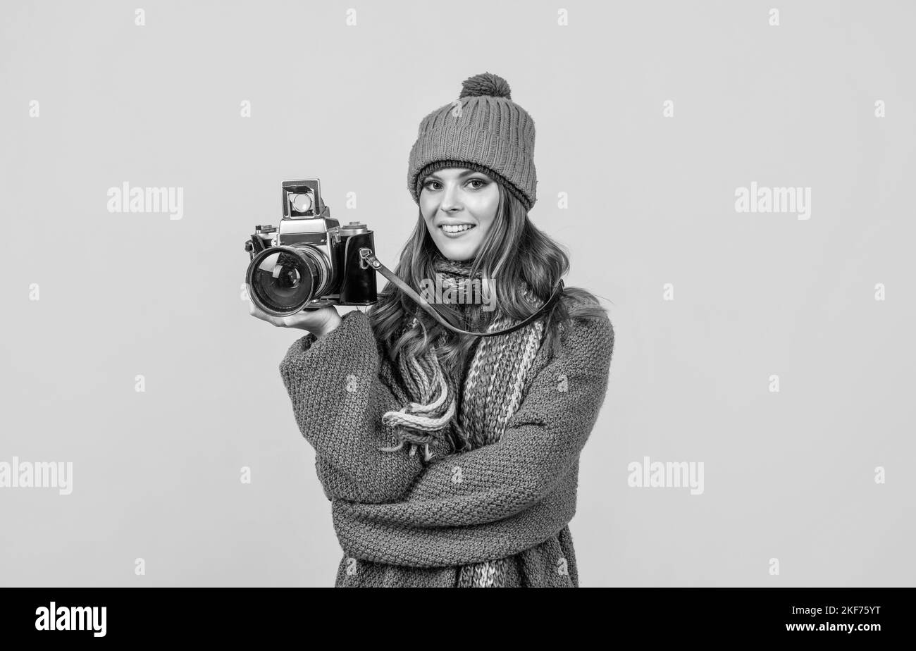 Happy female photographer hold photo camera yellow background ... Happy female photographer hold photo camera yellow background ...
