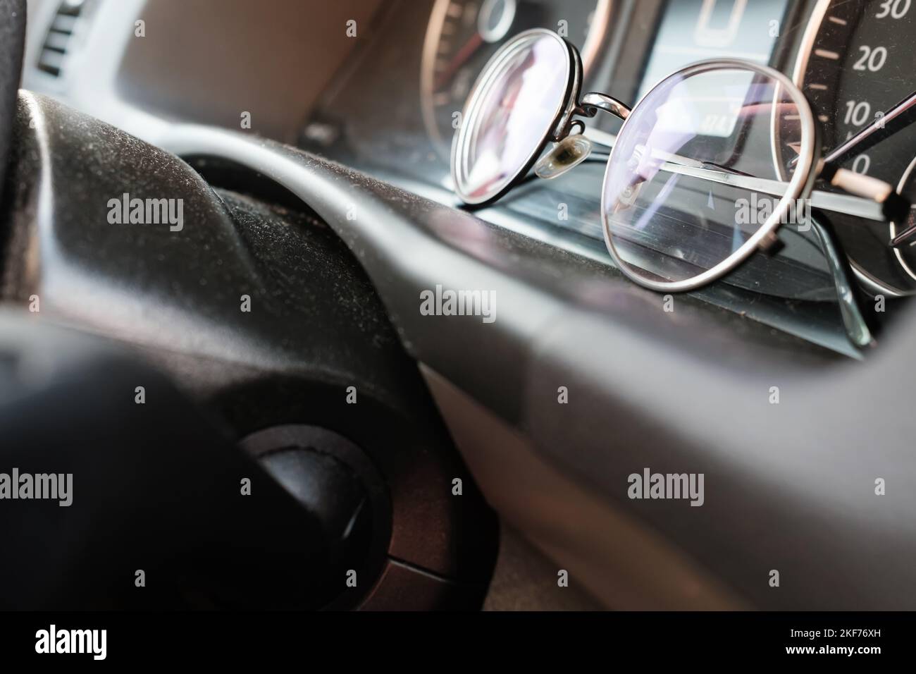 Glasses on the dashboard of a car. Accessory for drivers with vision ...