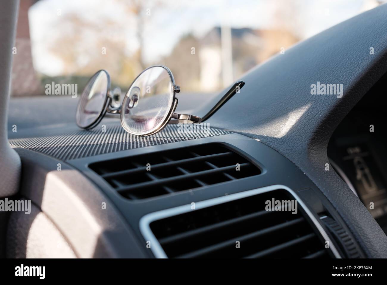 Glasses on the dashboard of a car. Accessory for drivers with vision ...