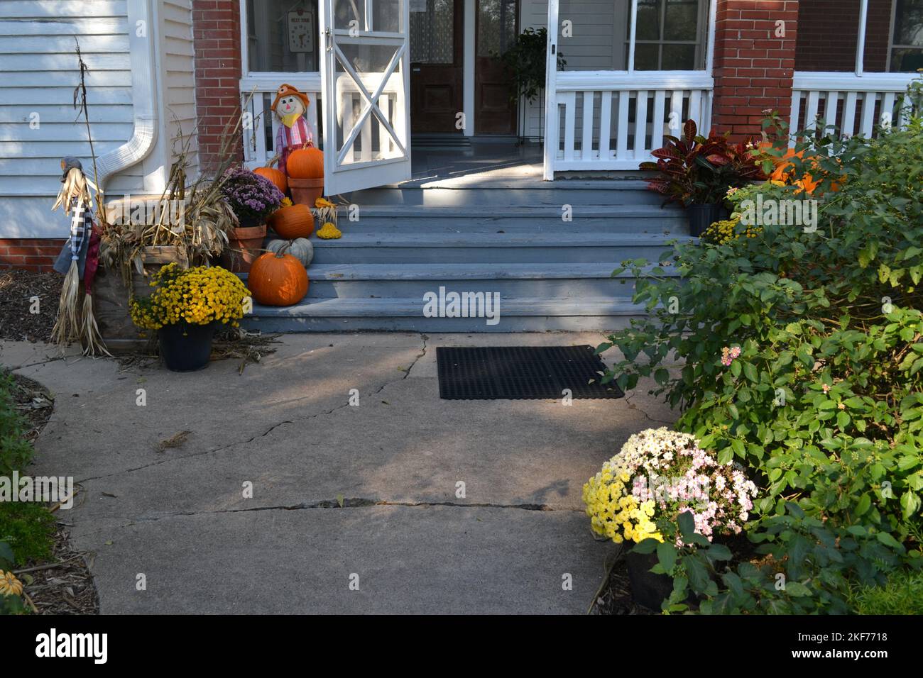An entrance to a house with fall flower and pumpkins composition Stock ...