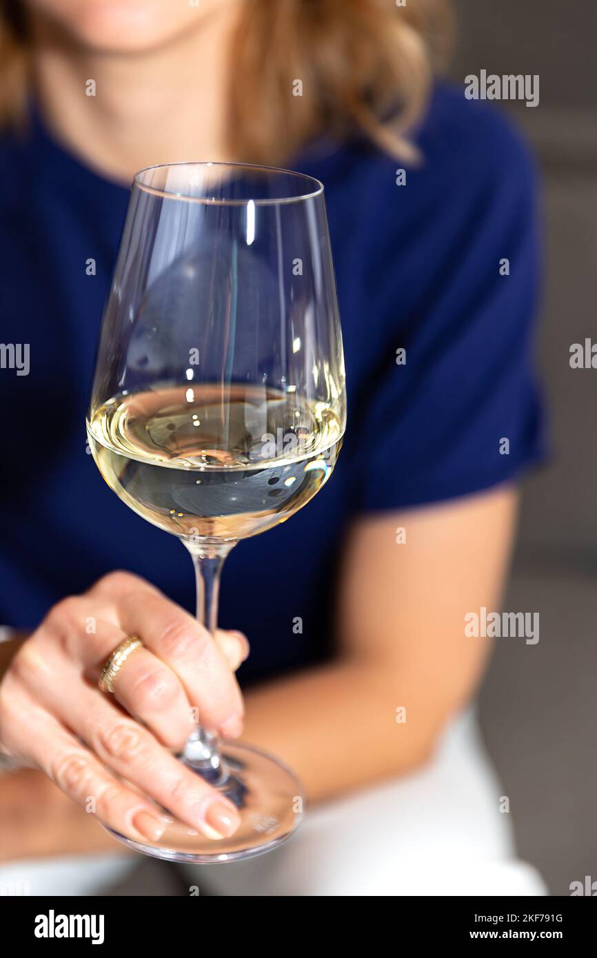 The glass of red, white wine on the table, in woman hand Stock Photo ...