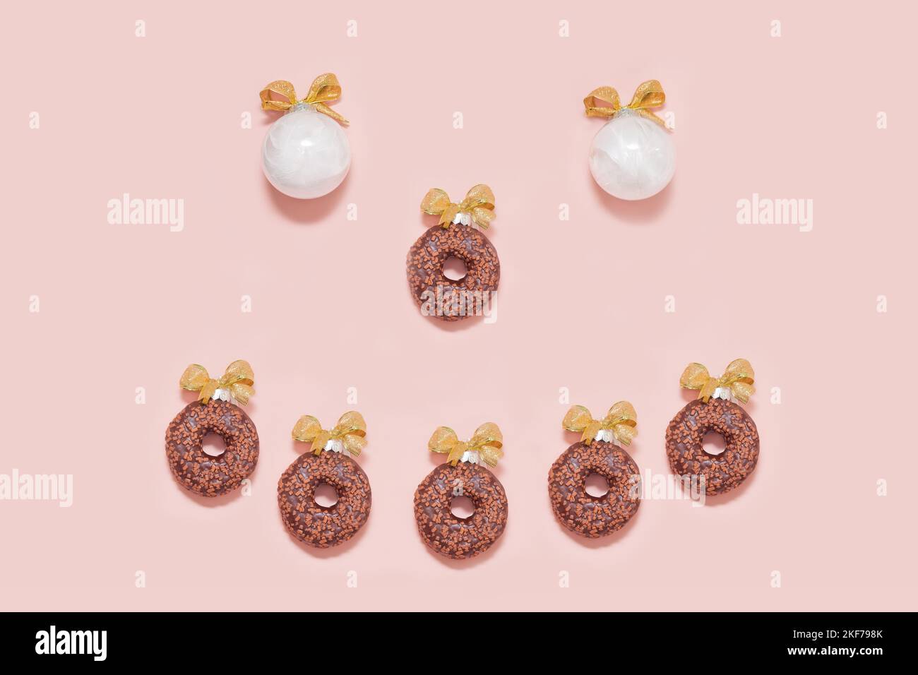 smiling white christmas balls wiht sweet donuts emoticon. new year ...