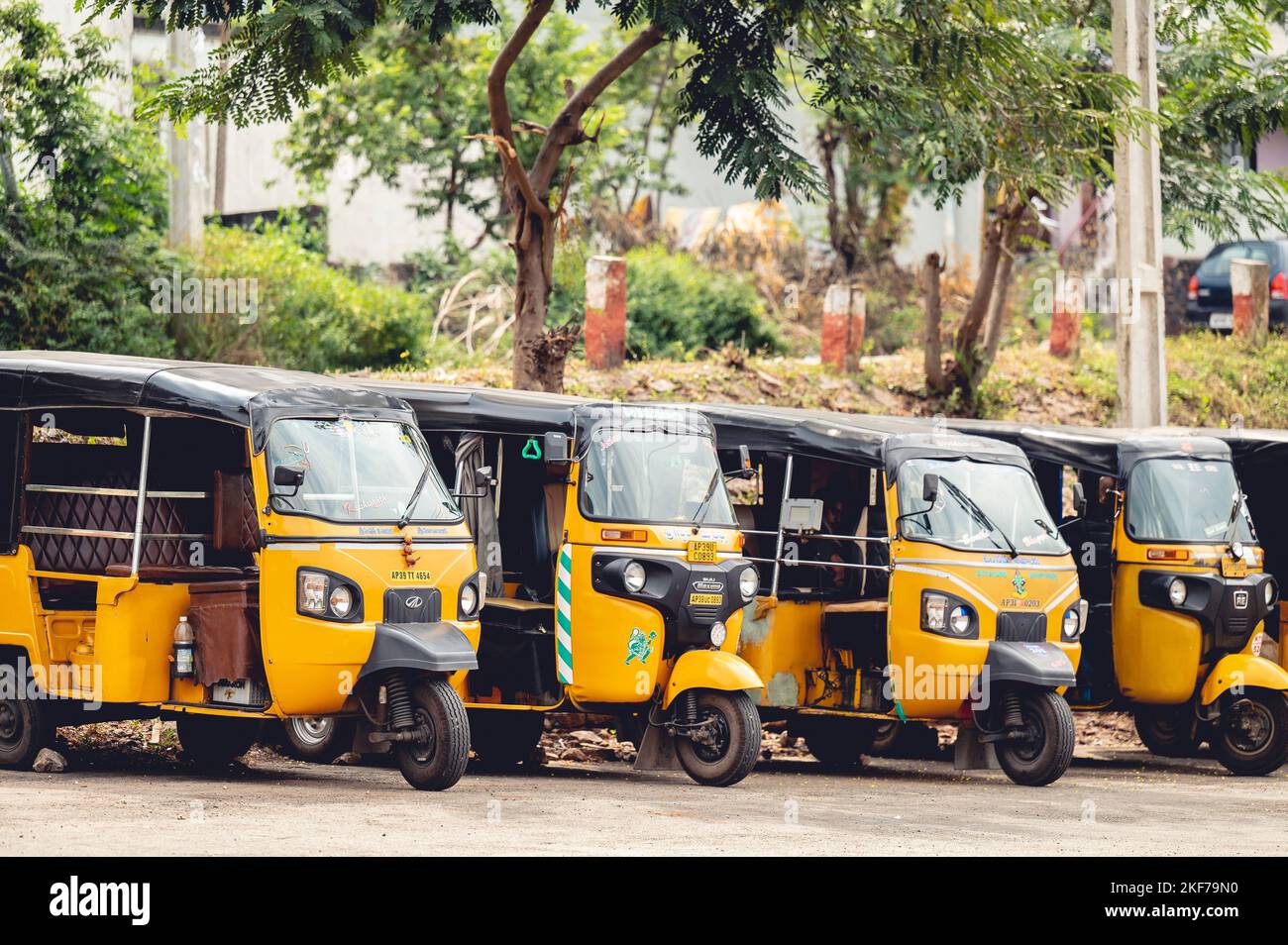 The yellow and black tricycle Tuk-Tuk taxi vehicles parking near the ...