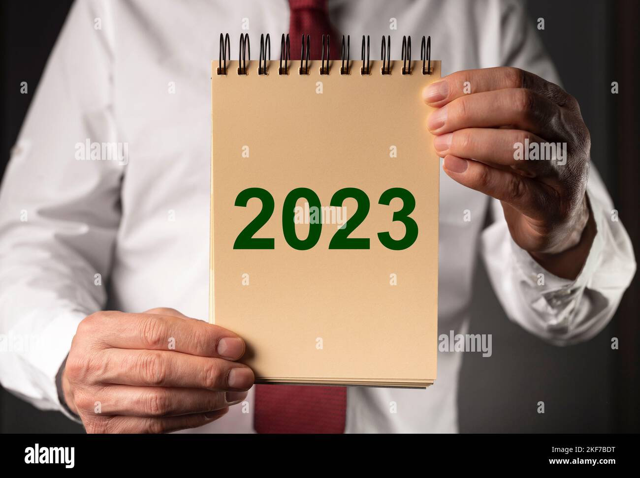 2023 new year on paper page of diary notebook in businessman hand ...