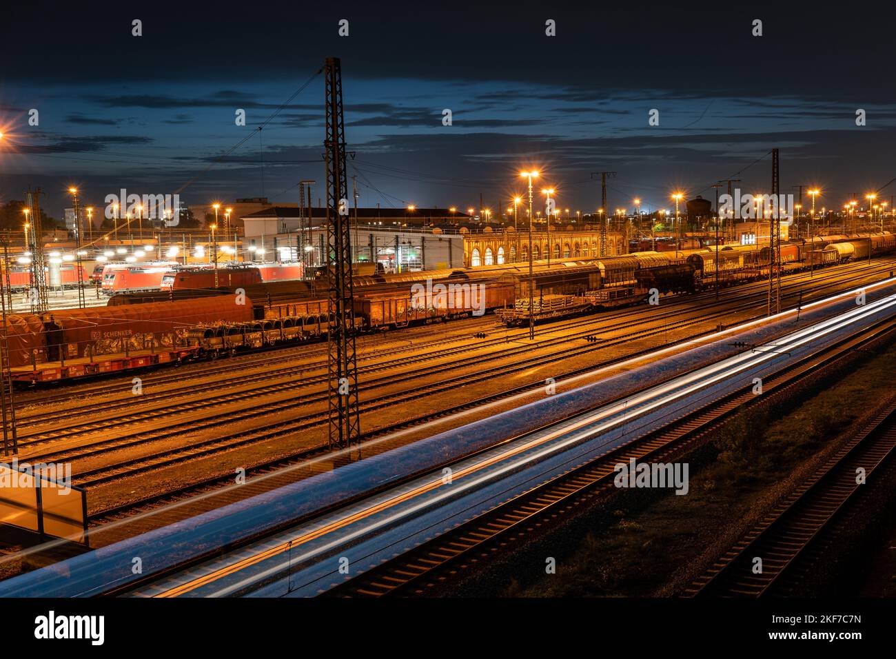 Cargo train station in Mannheim at night with moving train Stock Photo - Alamy