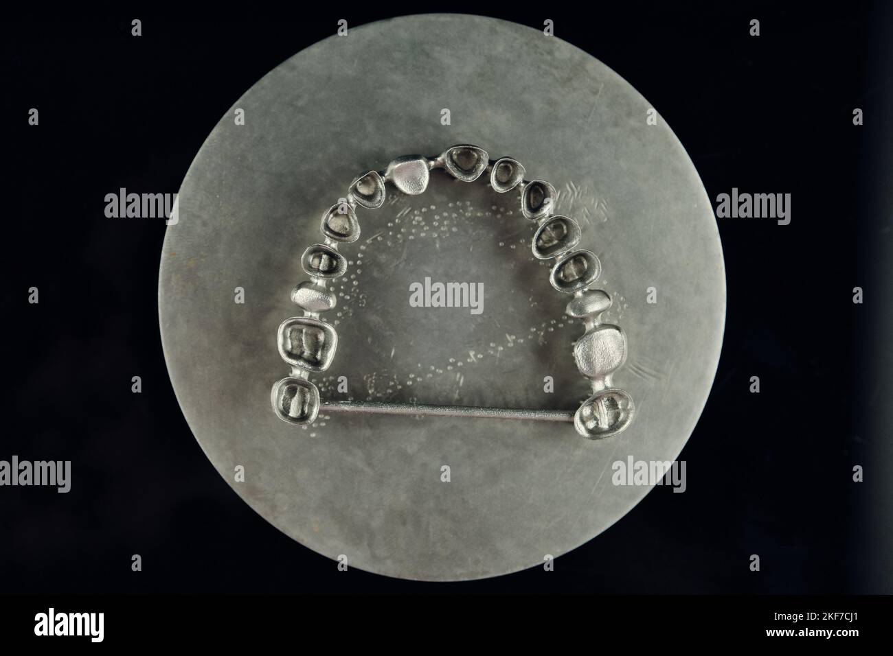 Close-up studio shot on milled metal frame for dental implants on the ...