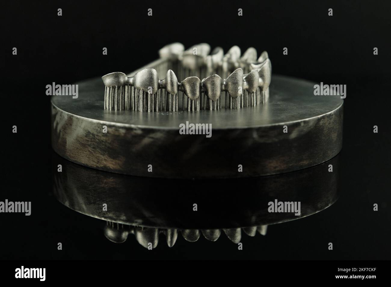 Close-up studio shot on milled metal frame for dental implants on the ...