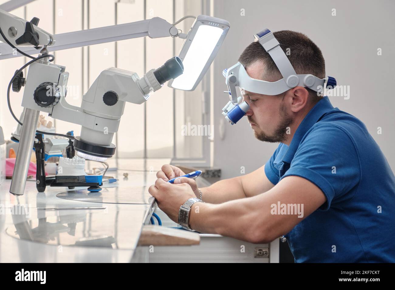 The dental technician is engaged in a modeling of artificial dentures ...