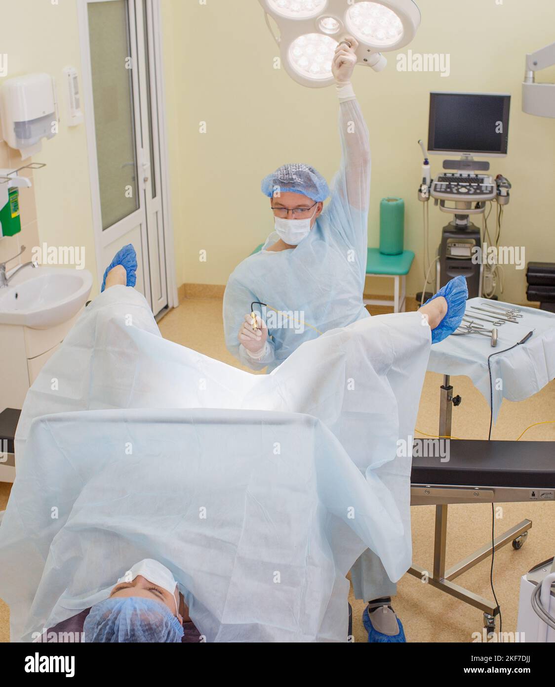 a proctologist examines a patient lying on a proctological chair in the ...
