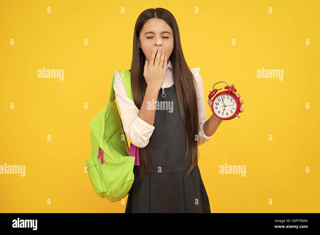 Back to school. Teenage school girl with bag hold clock alarm, time to ...