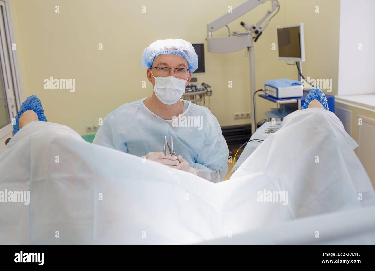 the proctologist looks into the camera during the examination of the ...