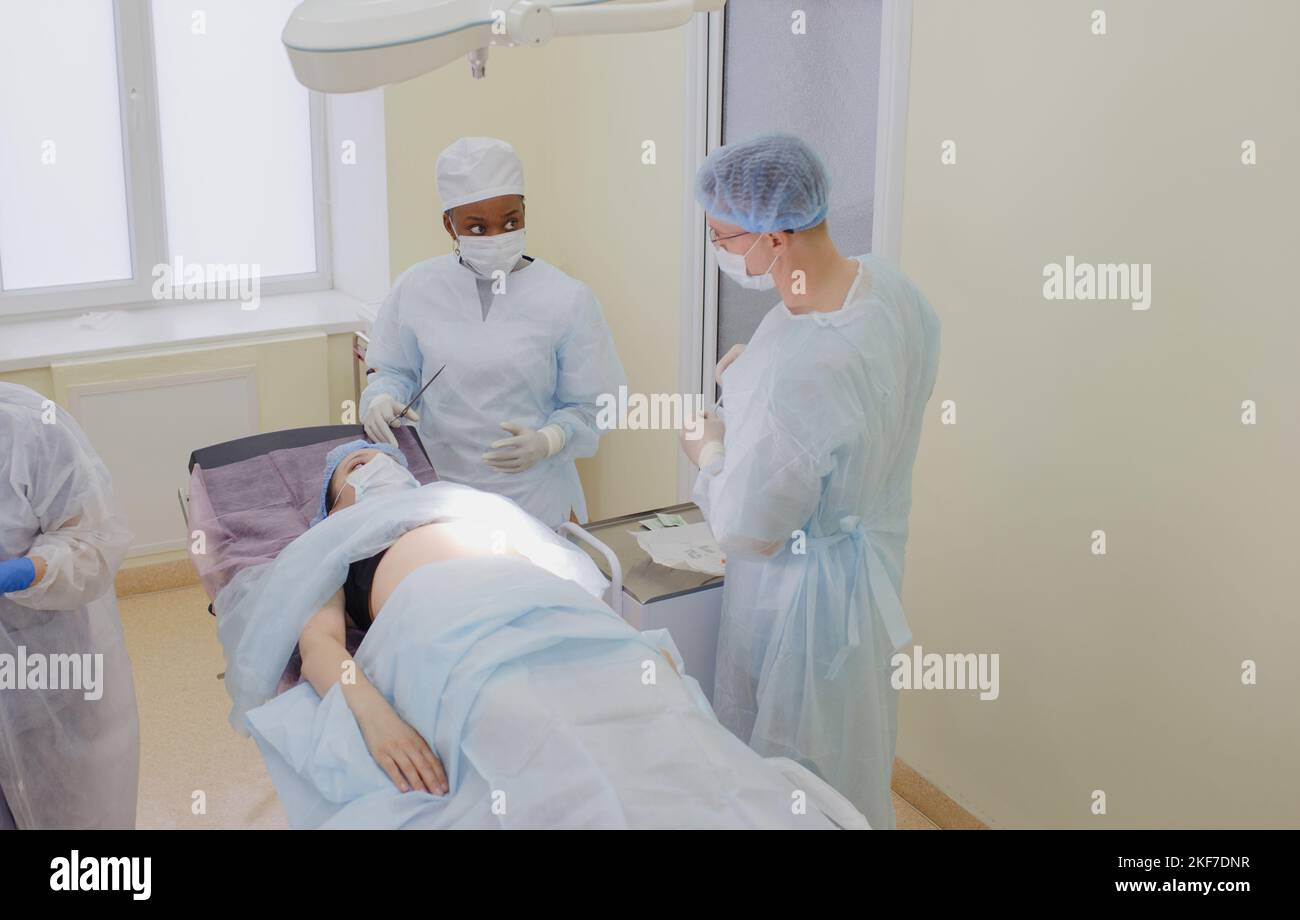 the surgeon and his assistant are preparing for the operation of a ...