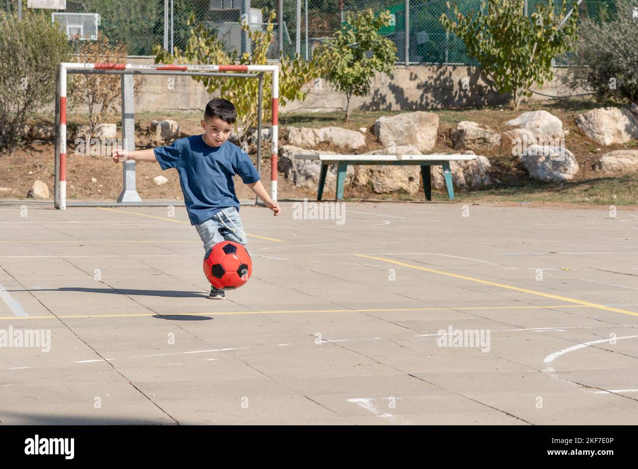 Cute Boy Playing Football. Little Child Kick Soccer Ball Stock Photo ...
