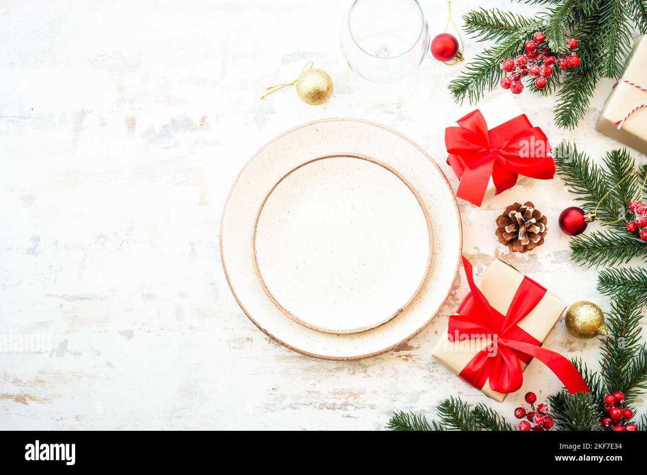 Christmas table setting with plate, cutlery and christmas decorations ...