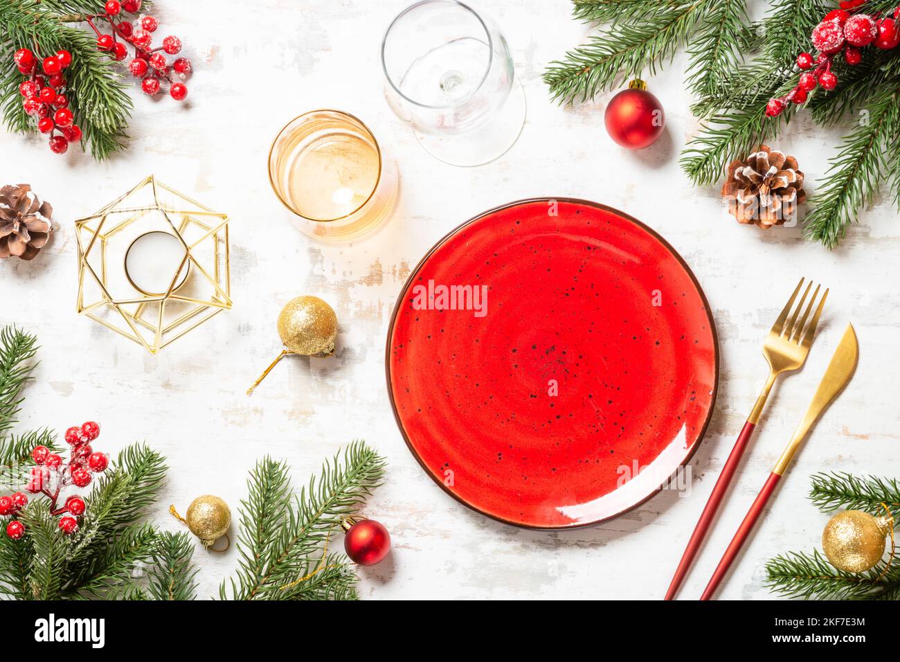 Christmas table setting with plate, cutlery and christmas decorations ...