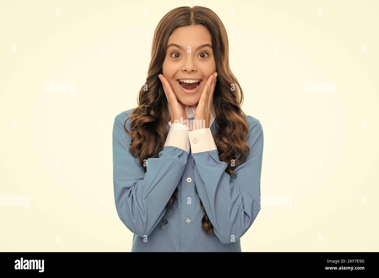 amazed kid portrait has long curly hair isolated on white, skincare ...