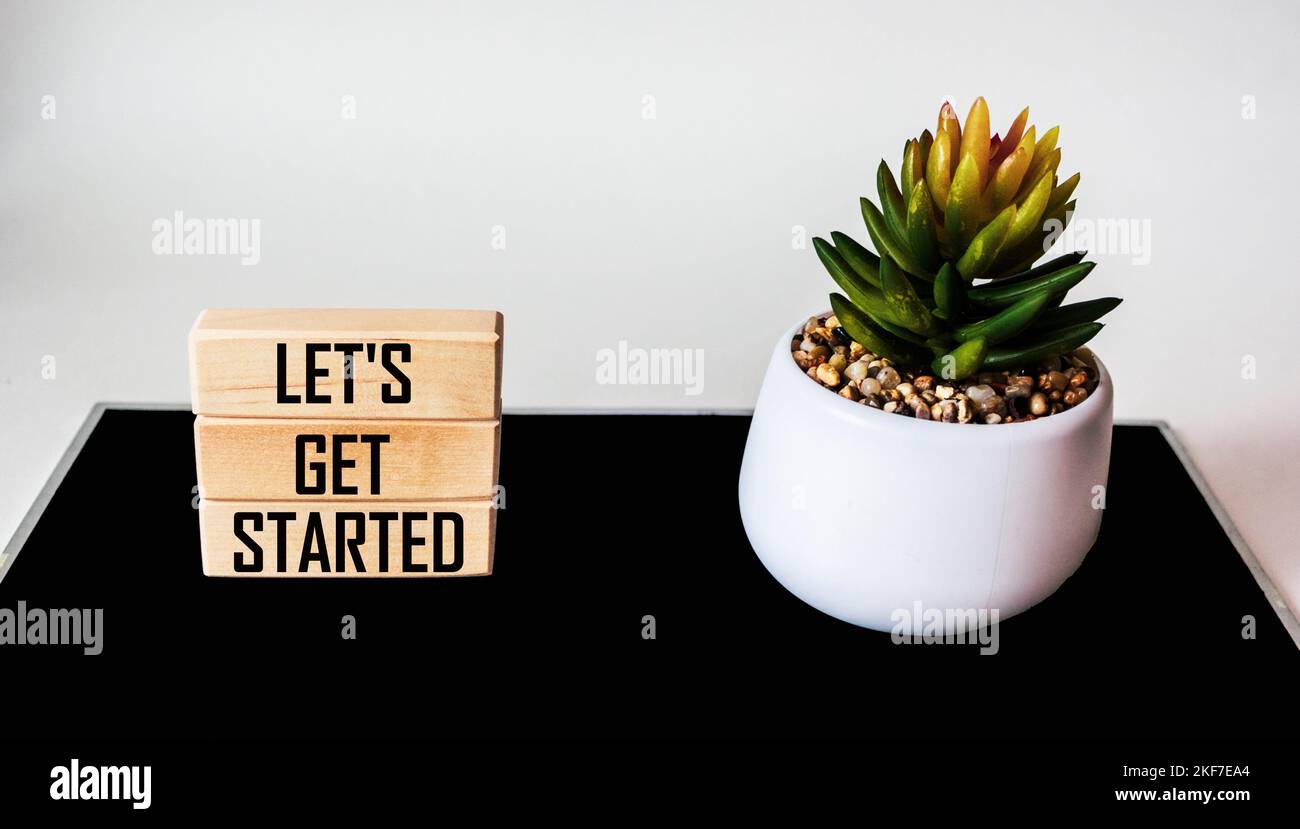 LET'S GET STARTED text on wood block with cactus flower, white and ...