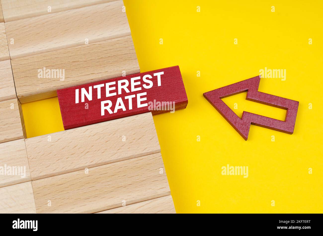Business concept. On a yellow surface are wooden blocks and an arrow ...
