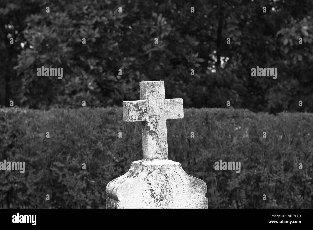 Christian cross standing in the cemetery as a gravestone in a black and ...
