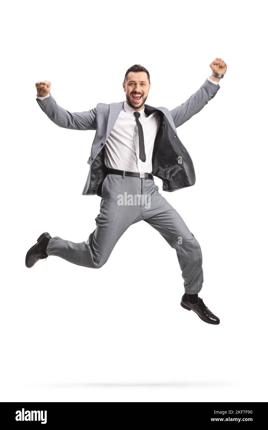 Excited young businessman in a grey suit jumping isolated on white ...