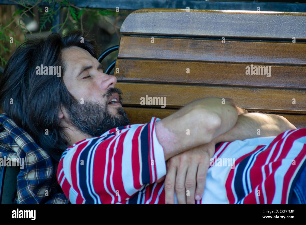 Bucharest, Romania - August 07, 2021: Homeless man sleeping on a bench ...