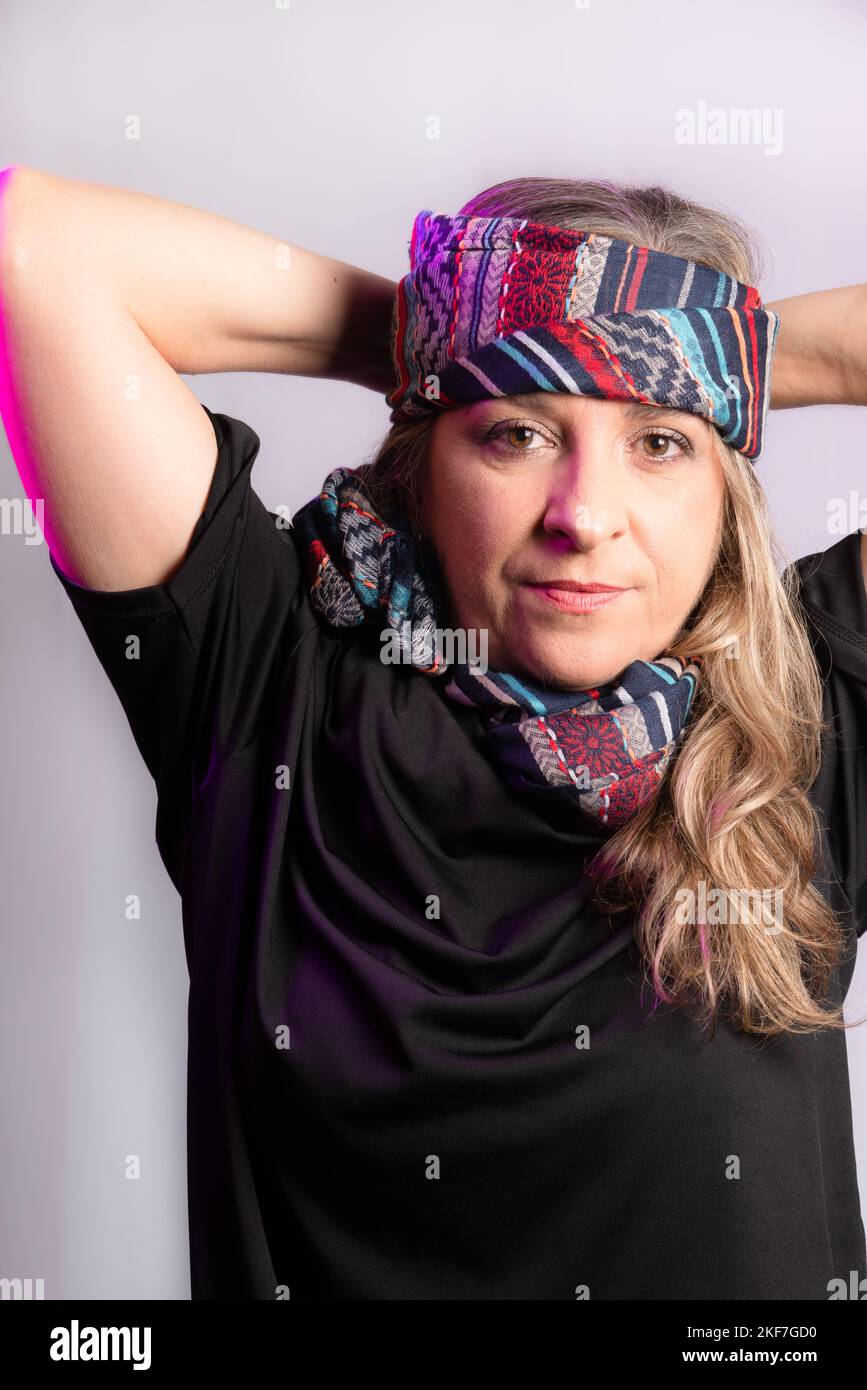 Beautiful woman holding cloth on forehead, looking at camera, isolated ...