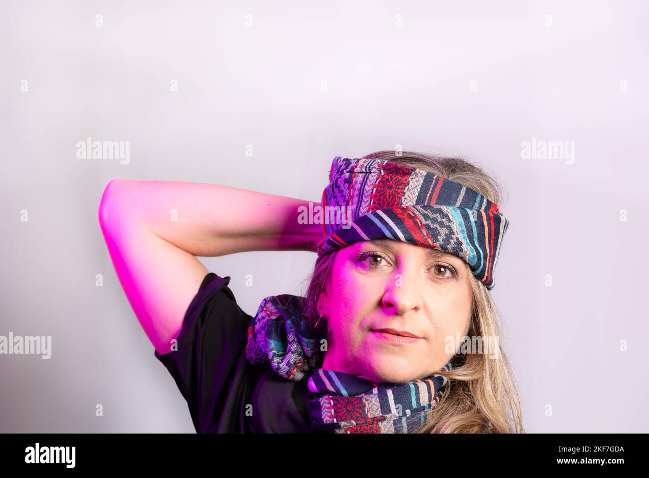 Beautiful woman holding cloth on forehead, looking at camera, isolated ...