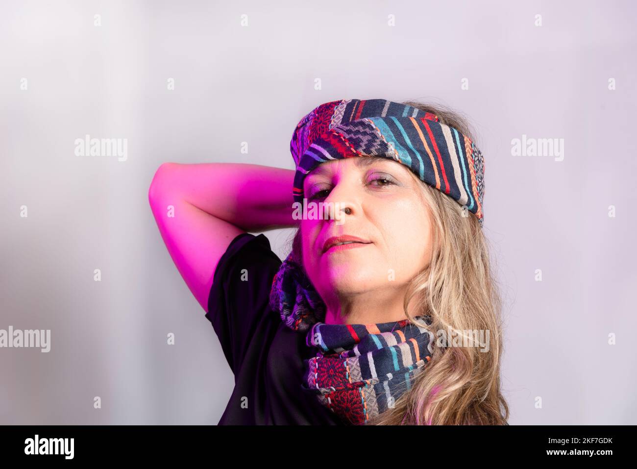 Beautiful woman holding cloth on forehead, looking at camera, isolated ...