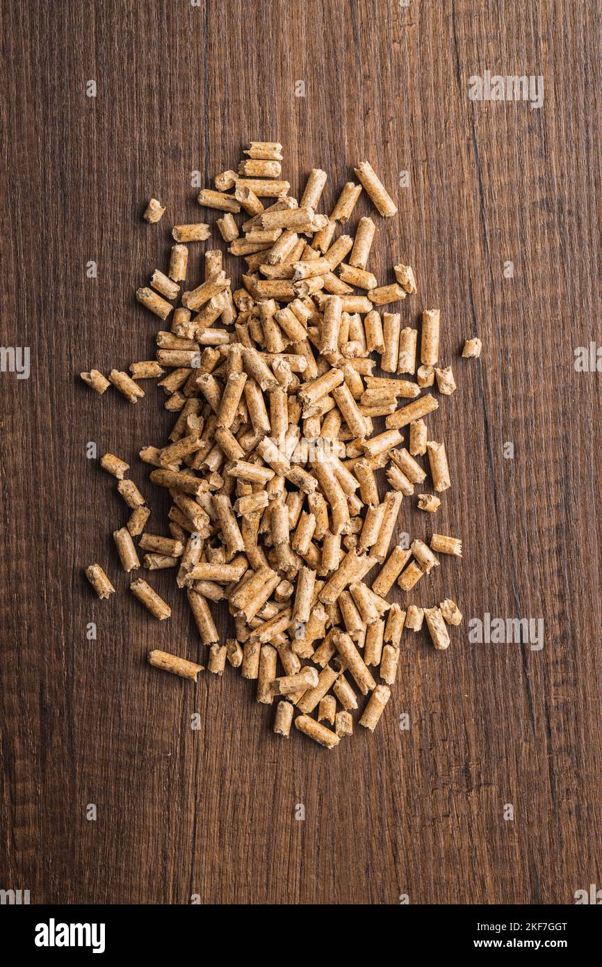 Wooden pellets on the wooden table. Top view Stock Photo - Alamy