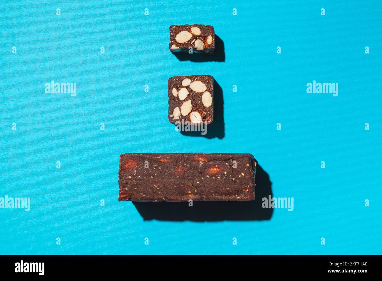 Protein date fruit candy bars fitness with nuts top view on blue ...