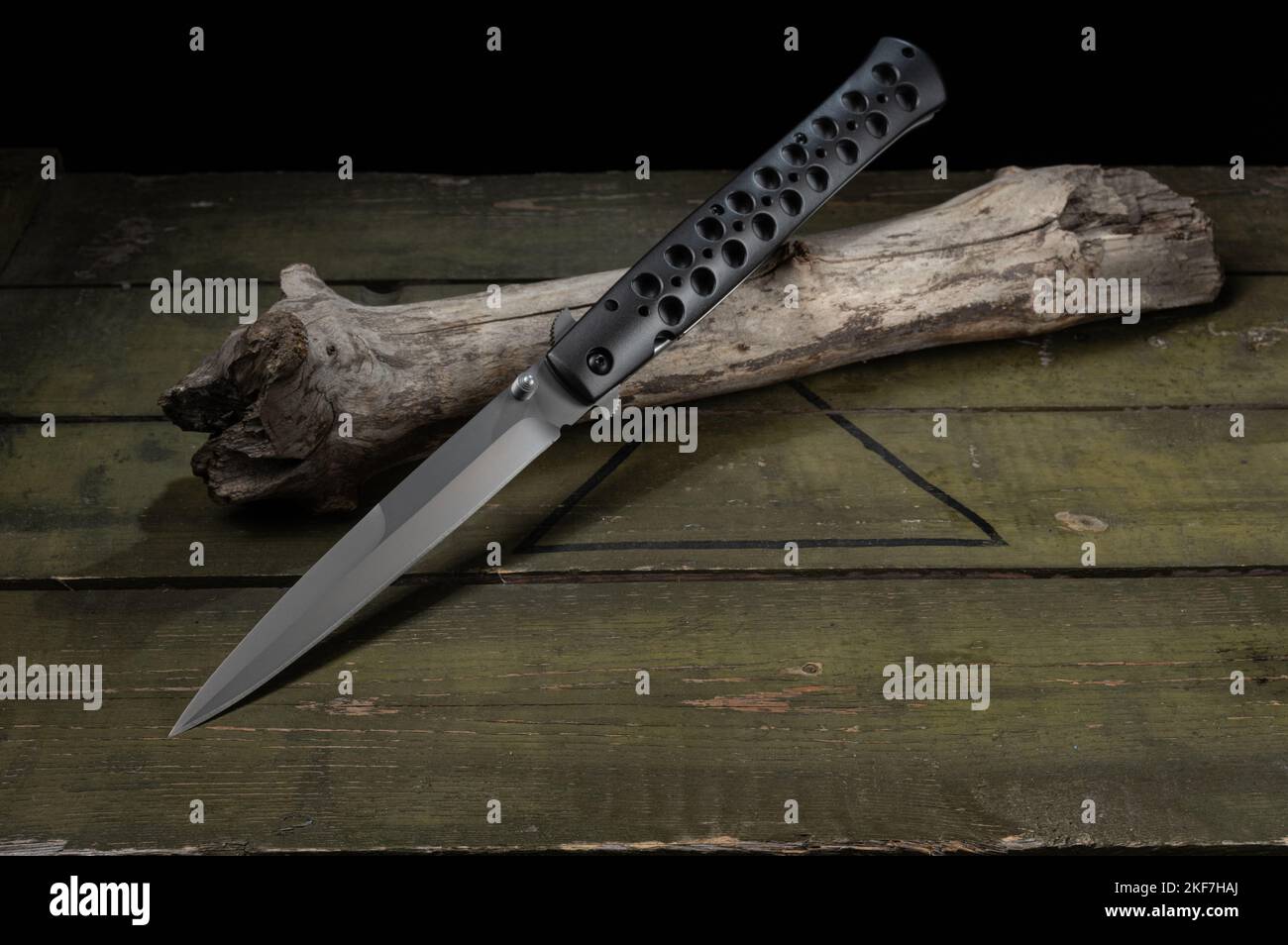 Large and narrow knife. Knife with double sharpened blade. Knife on a ...