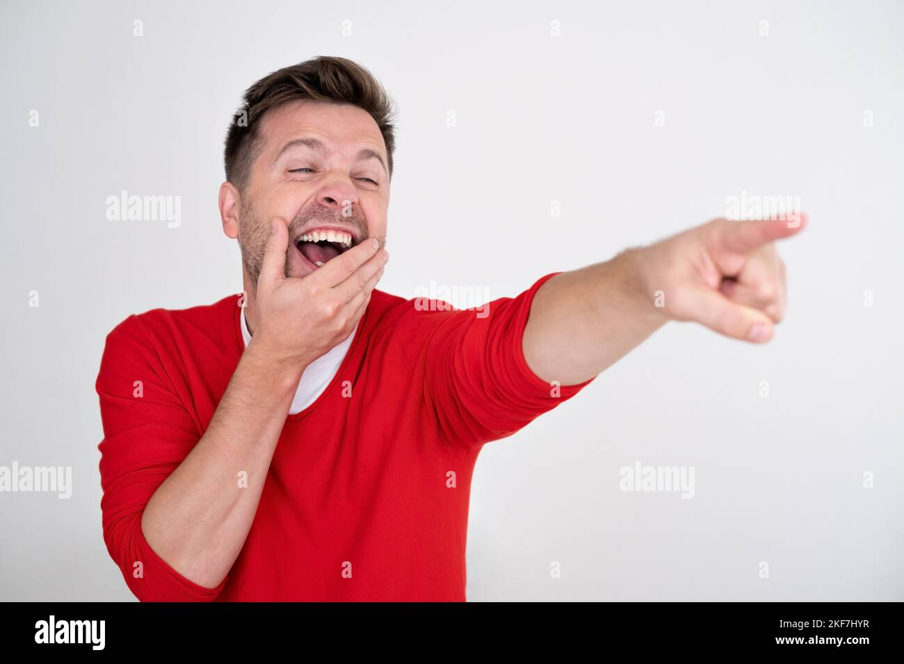 Man making fun of something laughing and pointing Stock Photo - Alamy
