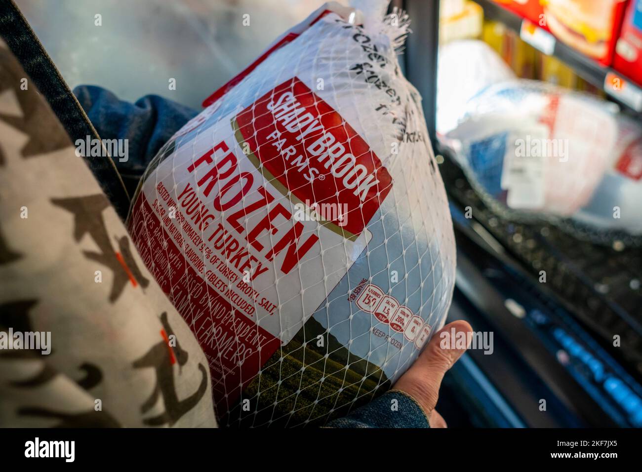 A shopper chooses a Shady Brook Farms brand frozen turkey in a ...