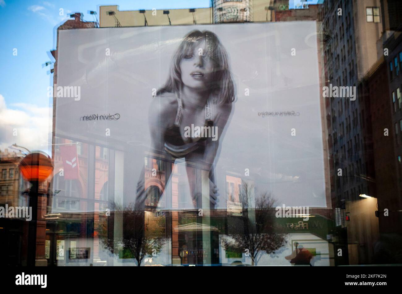 Shoppers walk past a Calvin Klein billboard advertising underwear ...