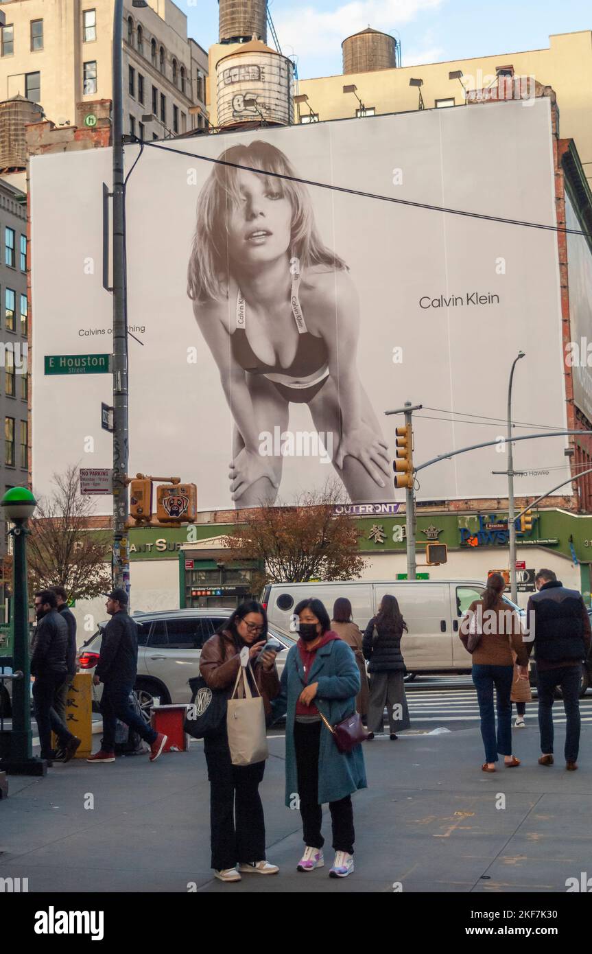 Shoppers walk past a Calvin Klein billboard advertising underwear ...