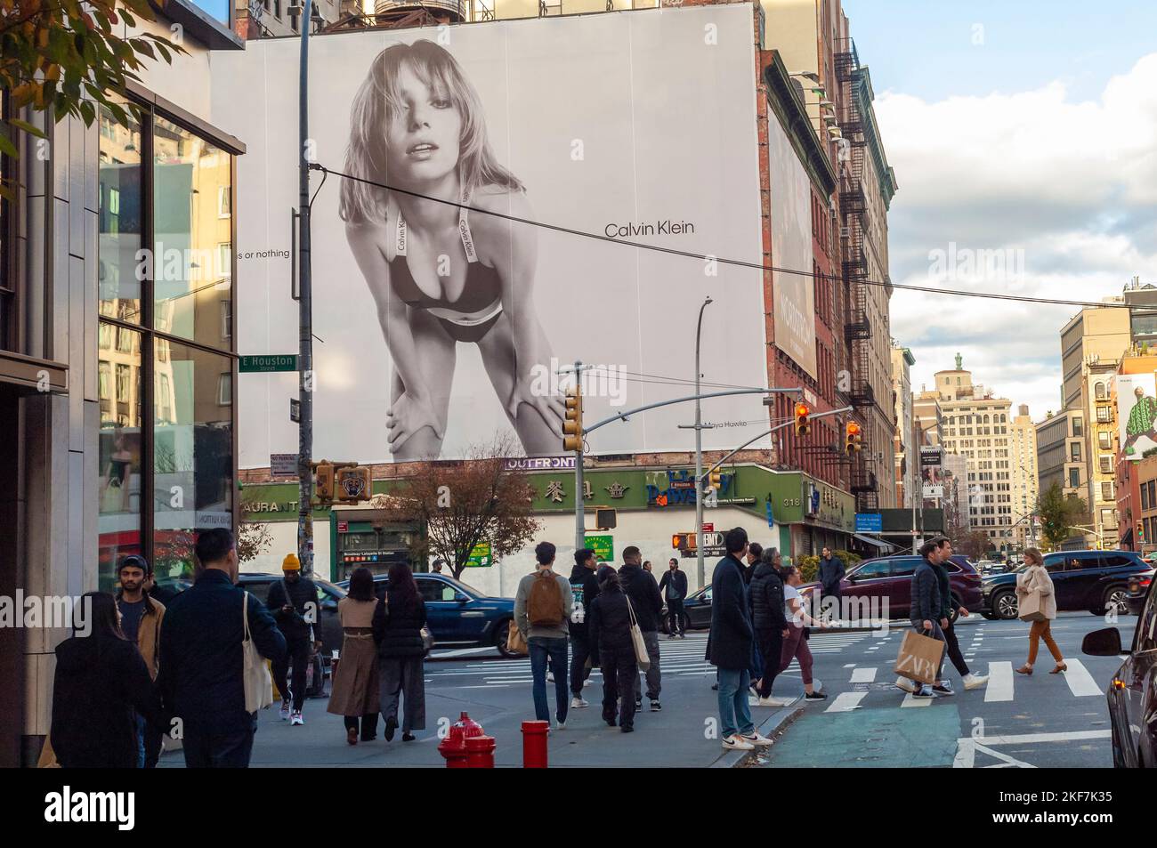 Shoppers walk past a Calvin Klein billboard advertising underwear ...
