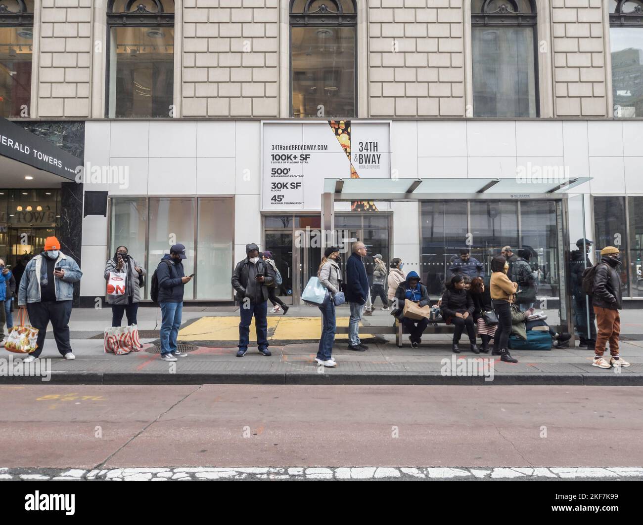 Passengers wait for the M34 SBS bus in Midtown Manhattan in New York on ...