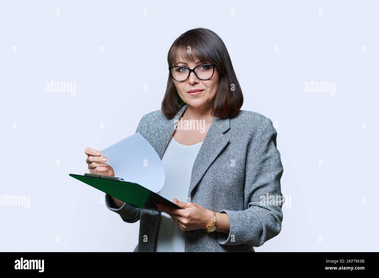 Business woman with clipboard on white studio background Stock Photo ...